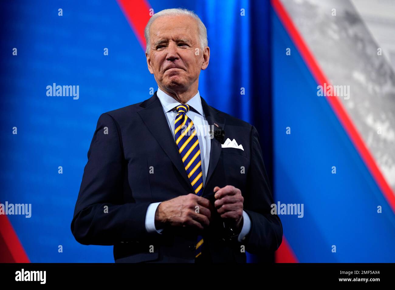 President Joe Biden stands on stage during a break in a televised town ...