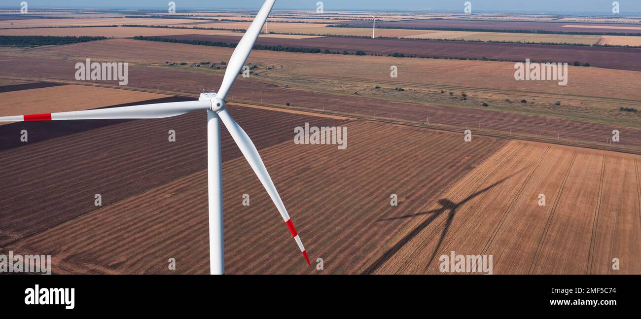 Wind turbines on flat terrain. Panorama. Green energy. Use of renewable ...