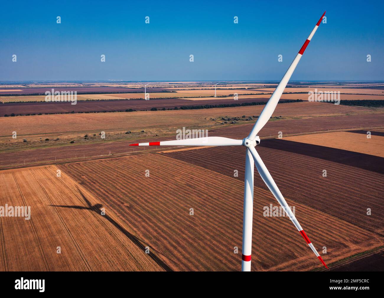 Wind turbines on flat terrain. Panorama. Green energy. Use of renewable ...