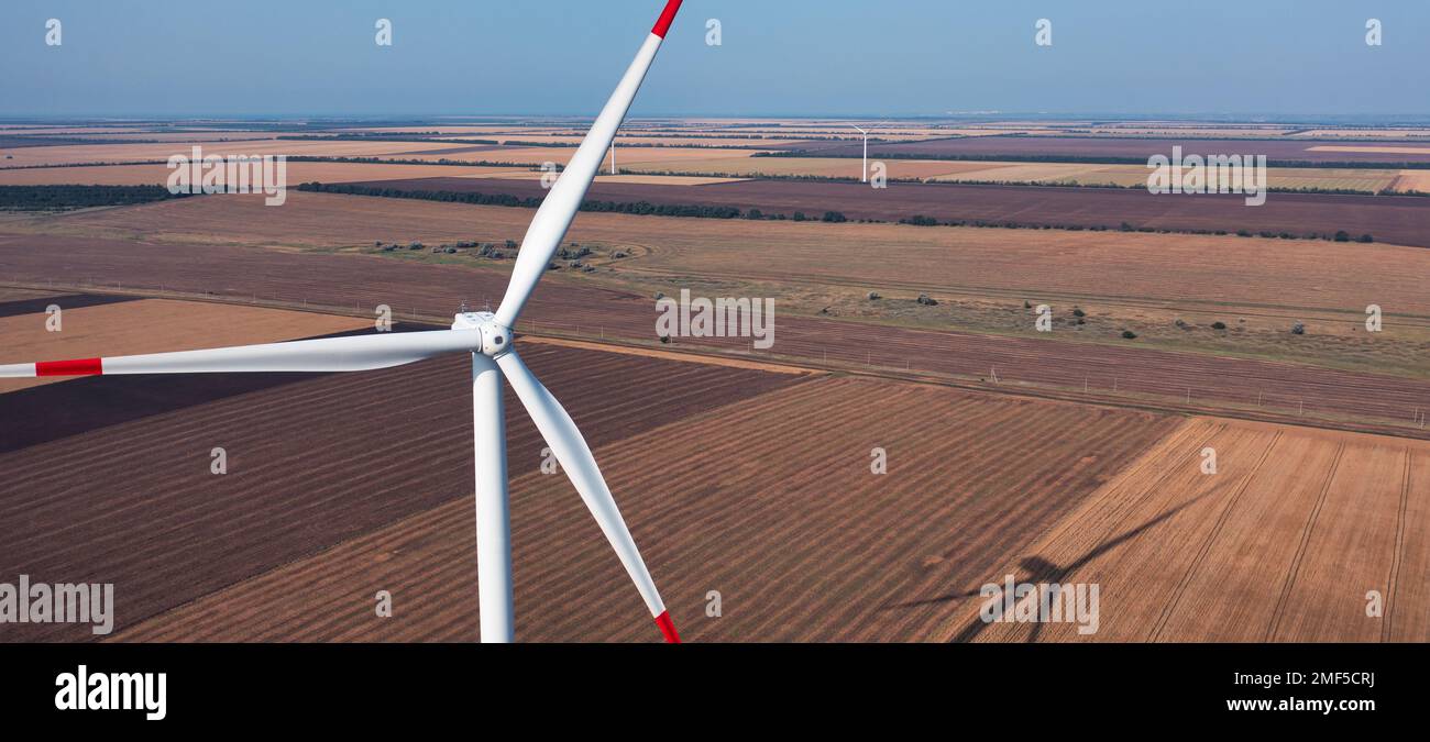 Wind turbines on flat terrain. Panorama. Green energy. Use of renewable ...