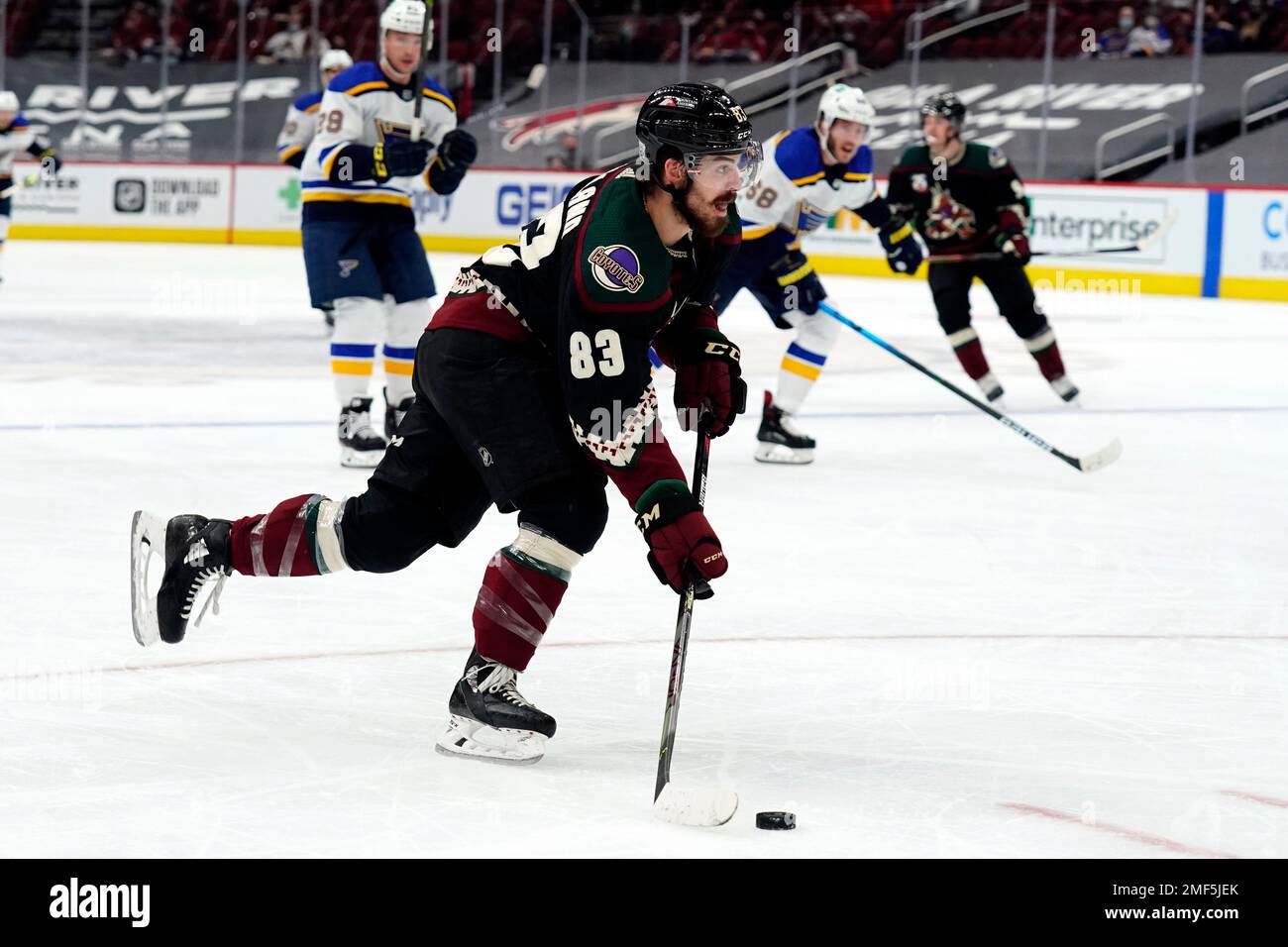 Arizona Coyotes right wing Conor Garland (83) drives toward the net ...