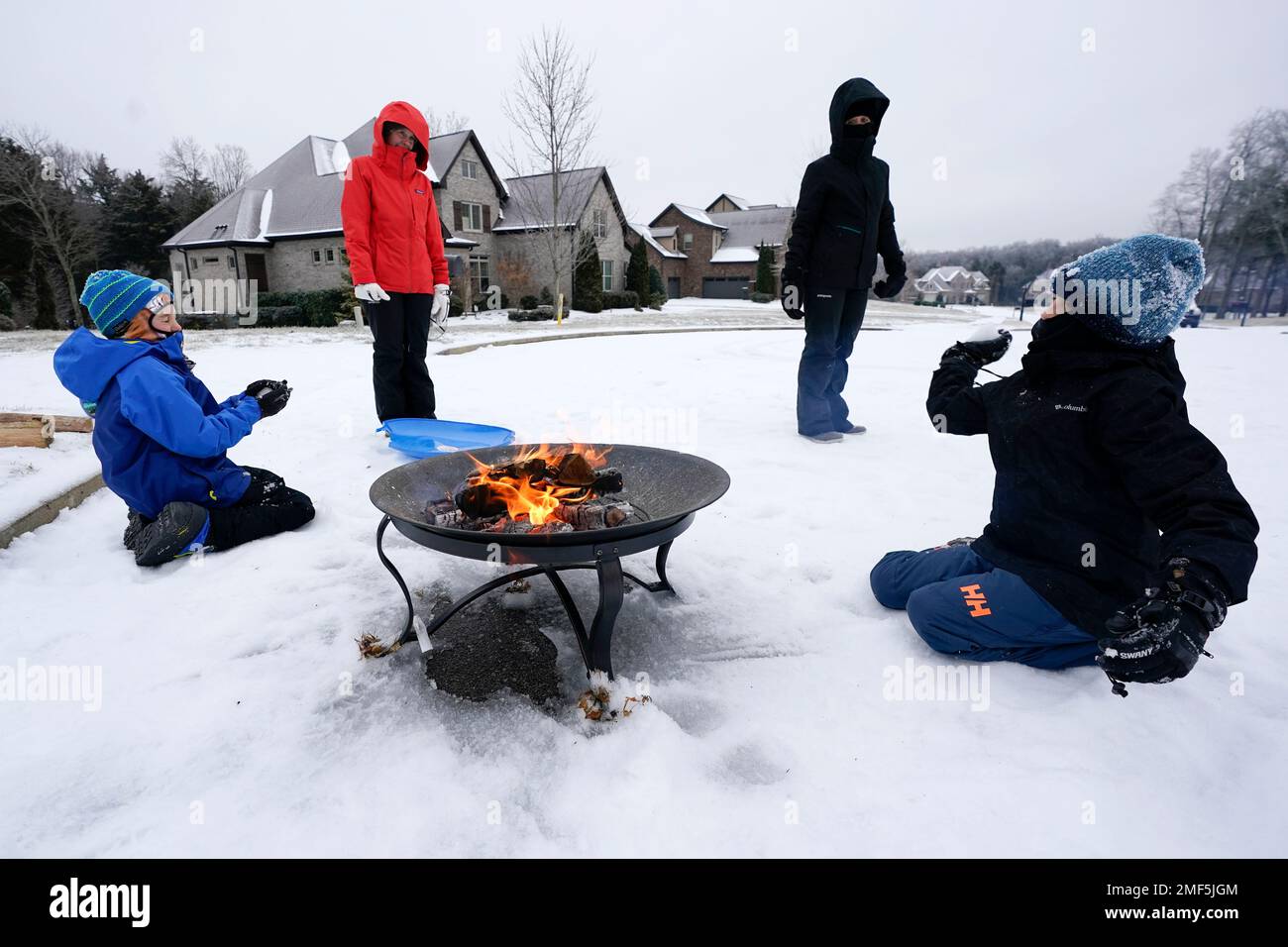 Luke Nolan, right, tosses a snowball at Connor Swyt, left, as neighbors ...