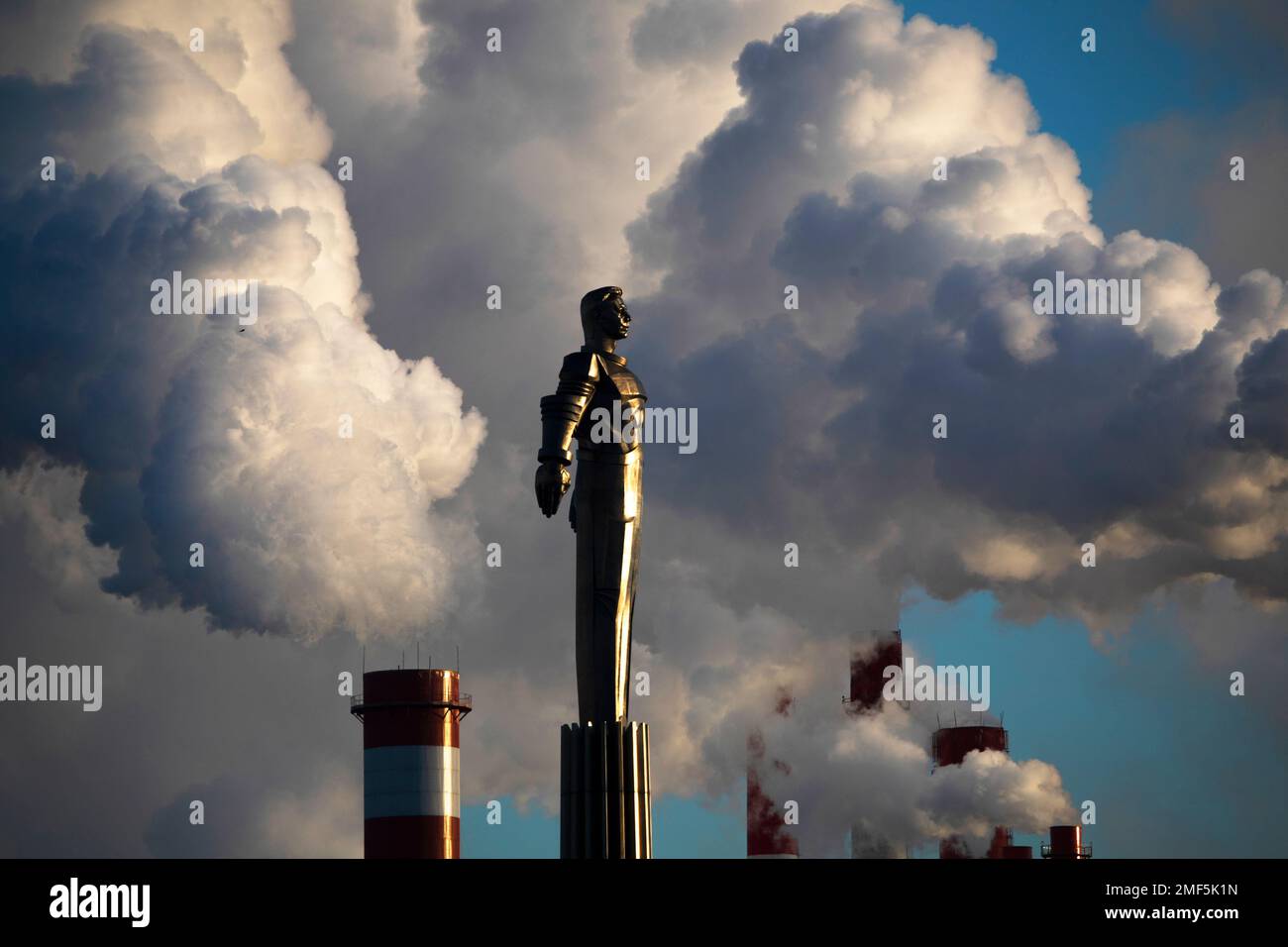 Steam rises from the heating plant behind a monument to Soviet ...