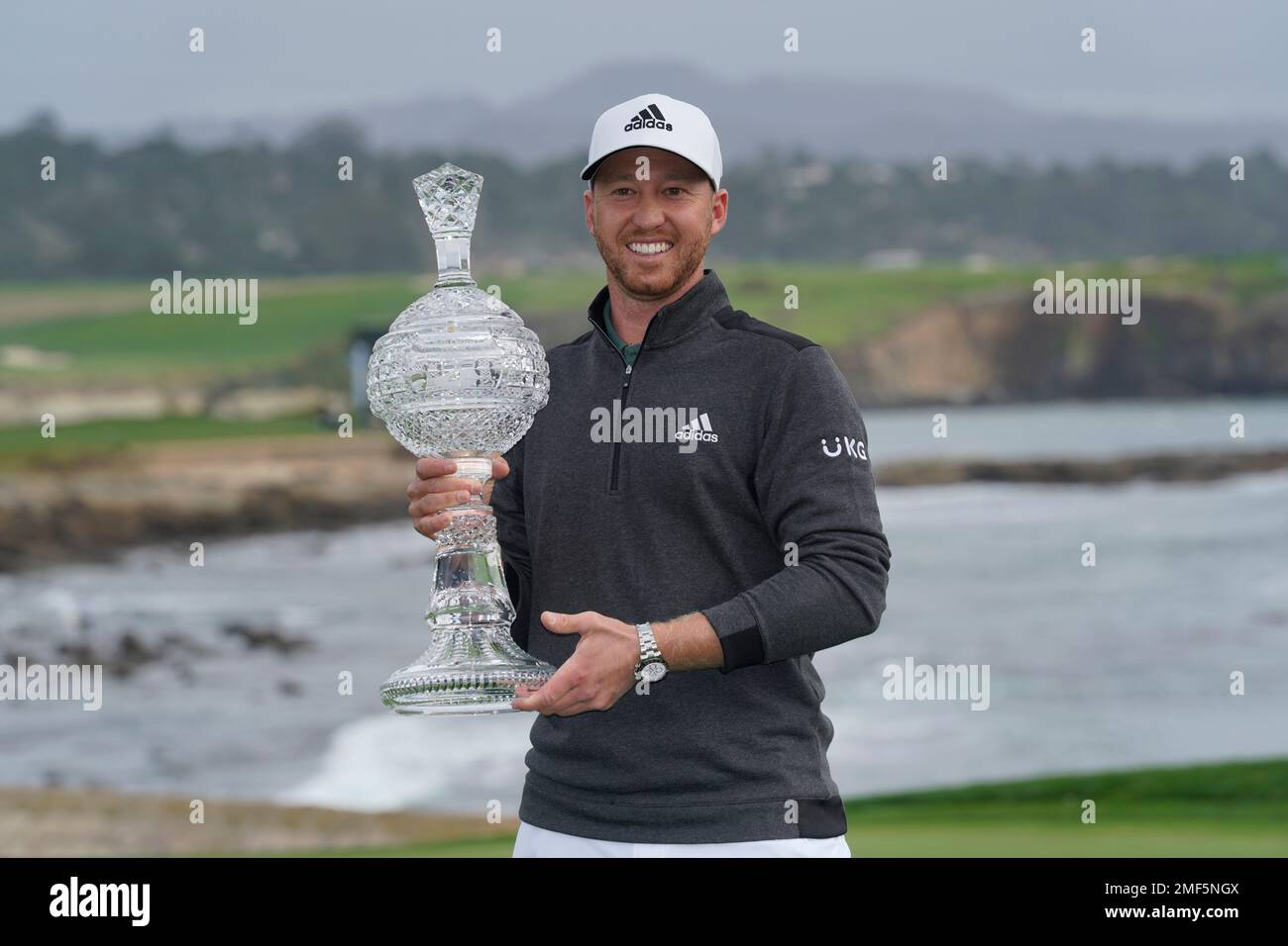 Daniel Berger poses with his trophy on the 18th green of the Pebble ...