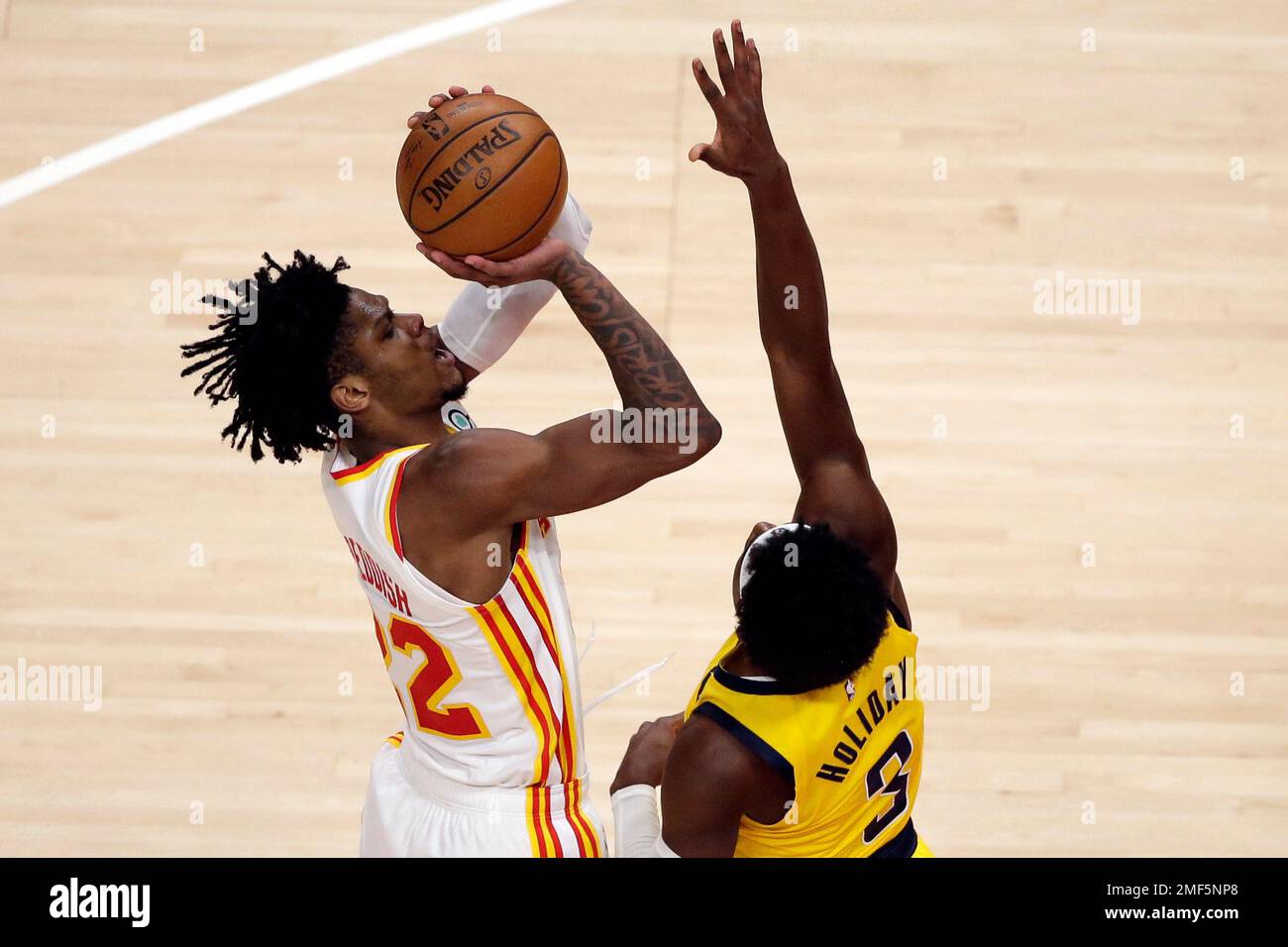 Atlanta Hawks guard Cam Reddish (22) puts up a shot over Indiana Pacers ...