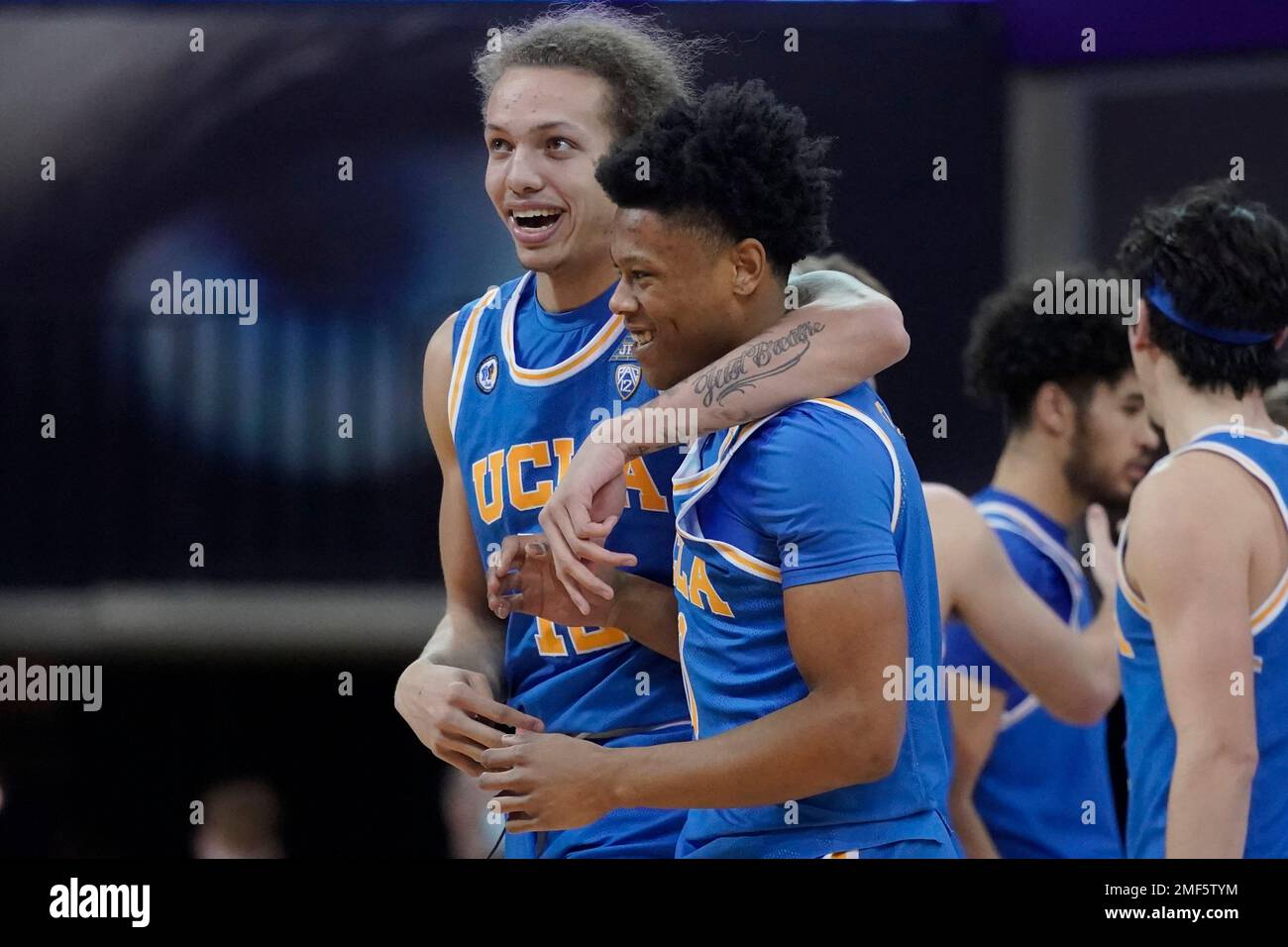 UCLA forward Mac Etienne, left, and guard Jaylen Clark, center, react ...
