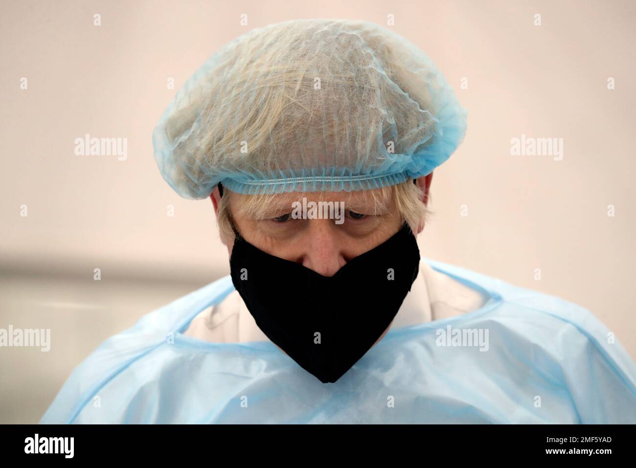 Britain's Prime Minister Boris Johnson, wearing a face mask to prevent ...