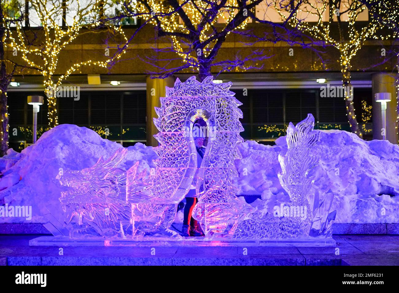 A woman passes a Lunar New Year ice sculpture at Brookfield Place ...
