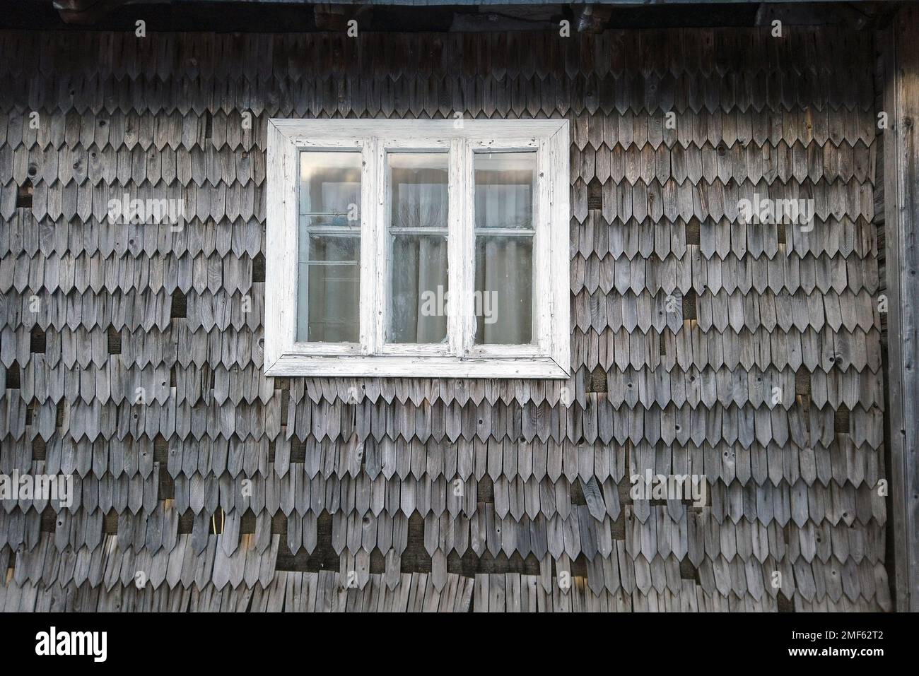 Old white window on the wall of Hutsul traditional house with gray ...