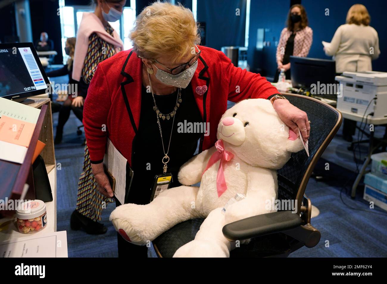 Virginia Senate clerk, Susan Schaar, looks over a teddy bear that was ...