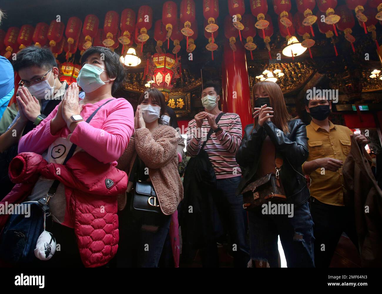 People wear face masks to help curb the spread of the coronavirus as ...