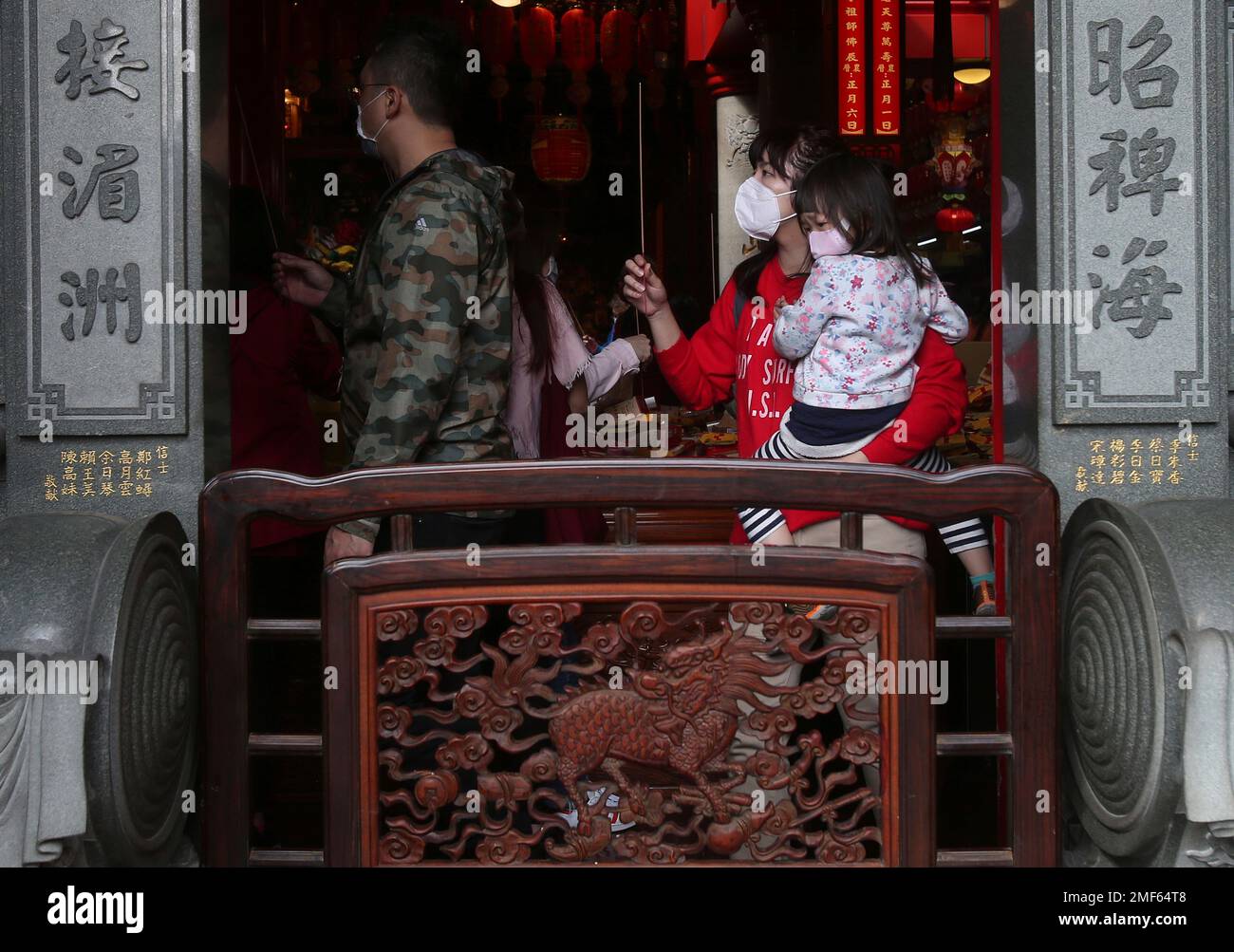 People wear face masks to help curb the spread of the coronavirus as ...