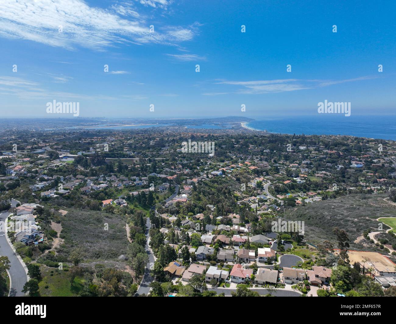 Aerial view over La Jolla Hills with big villas and ocean in the ...