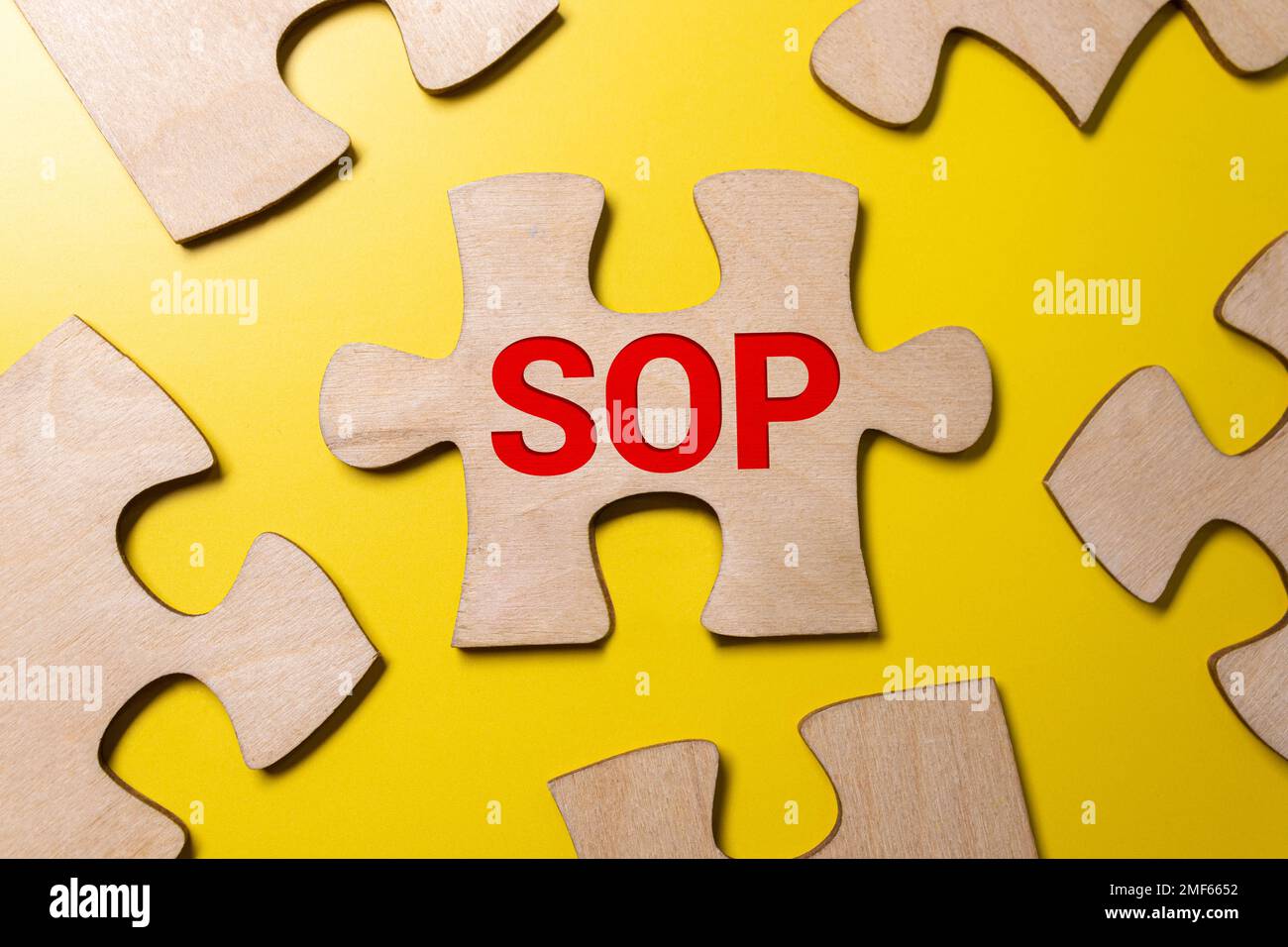 On a bright red background, white puzzles. In one of the pieces of the ...