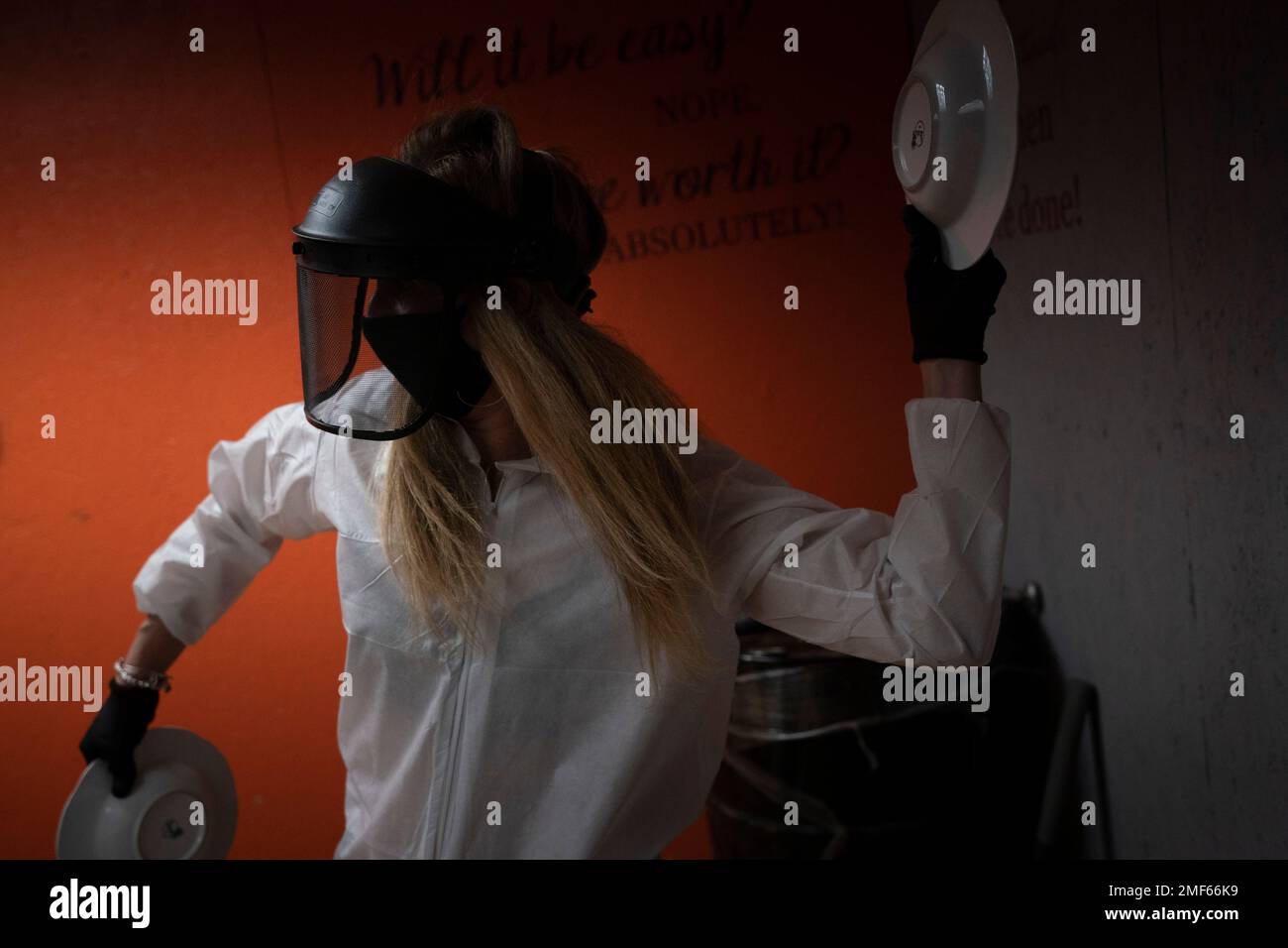 Asia Made, 50, smashes plates into a wall in a rage room during a ...