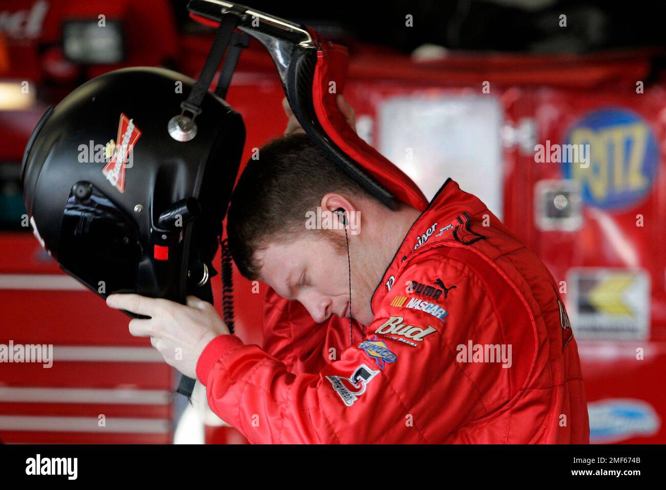 FILE - In this Feb. 18, 2006, file photo, Dale Earnhardt Jr., puts on his helmet and protective ...
