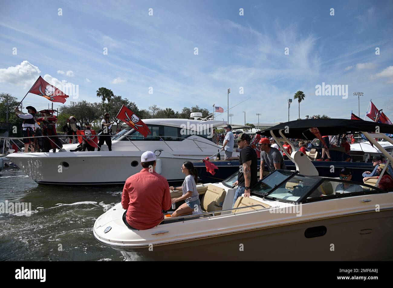 Fans crowd the waterway while following boats carrying Tampa Bay ...