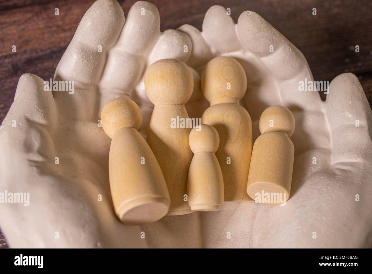 A mother and a child hold a family cut out of paper in their hands ...