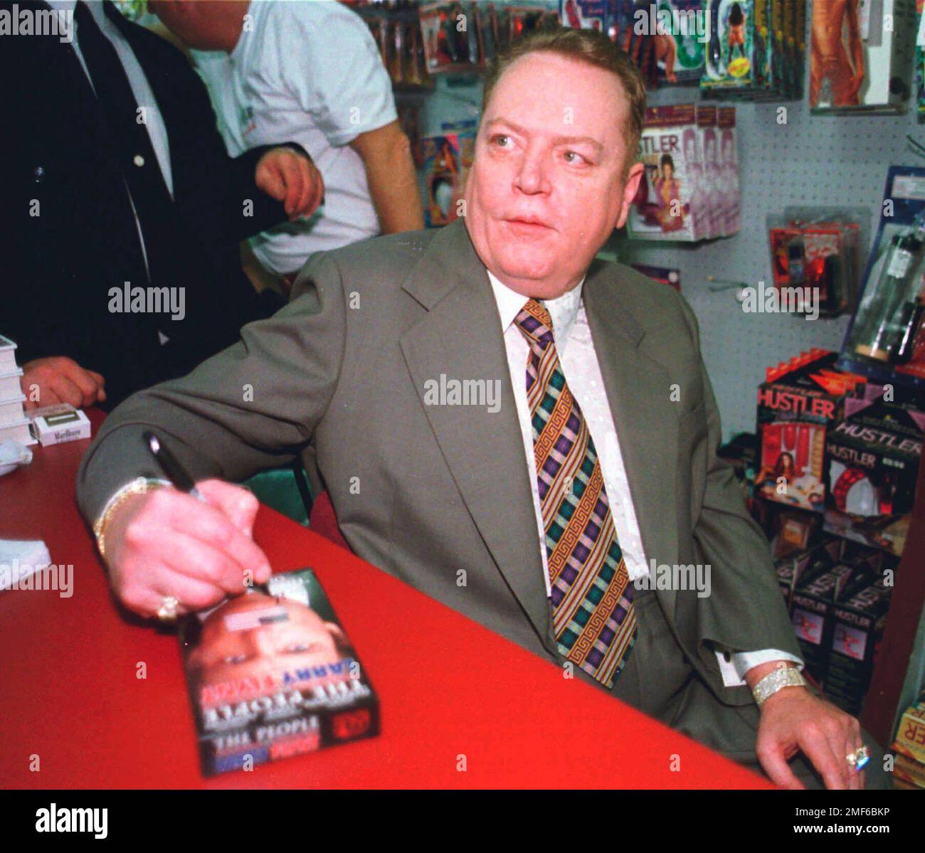 FILE - "Hustler" Magazine publisher Larry Flynt signs a copy of "The ...