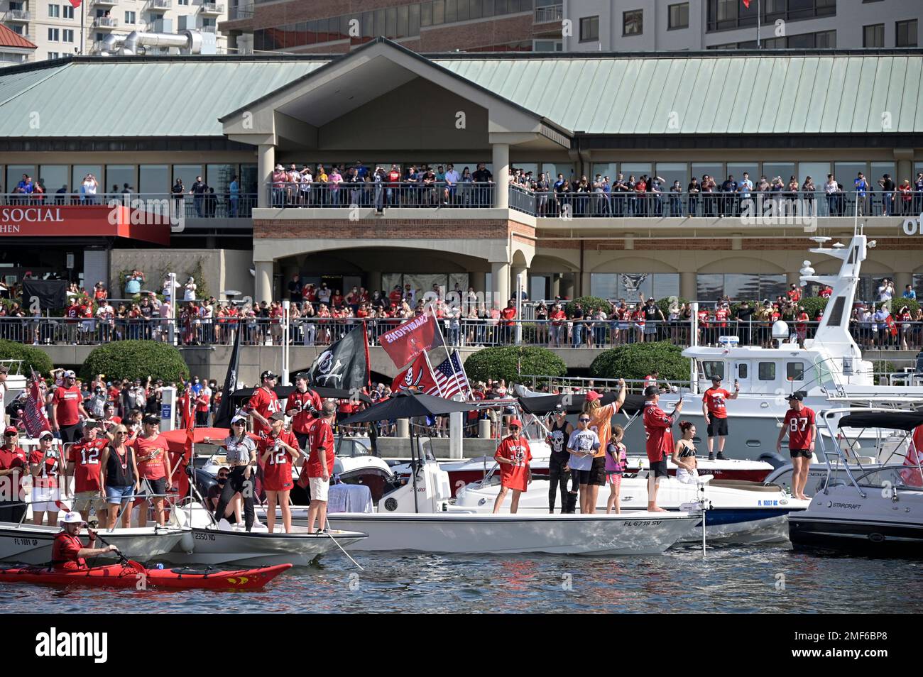 Fans watch as members of the Tampa Bay Buccaneers float down a river ...