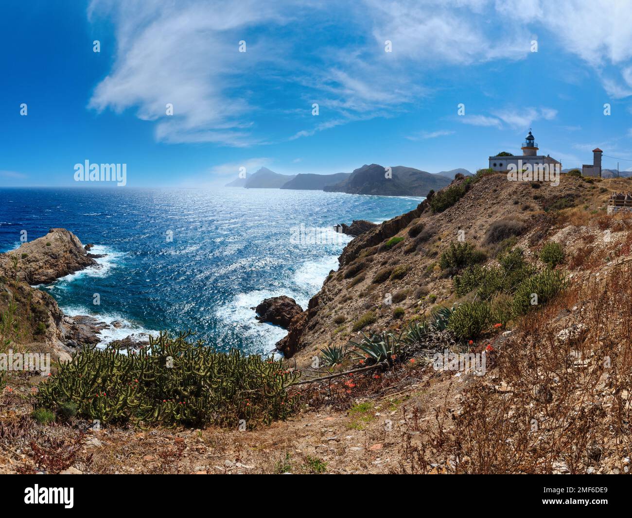 Mediterranean sea summer rocky coast view and lighthouse El hoyo del ...