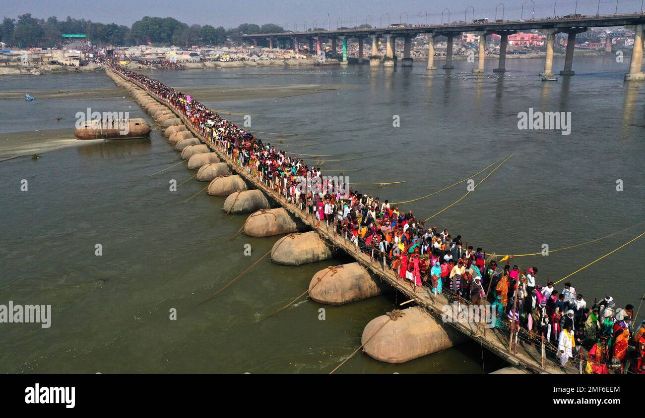 Indian Hindu devotees with their belongings arrive for a holy dip at ...