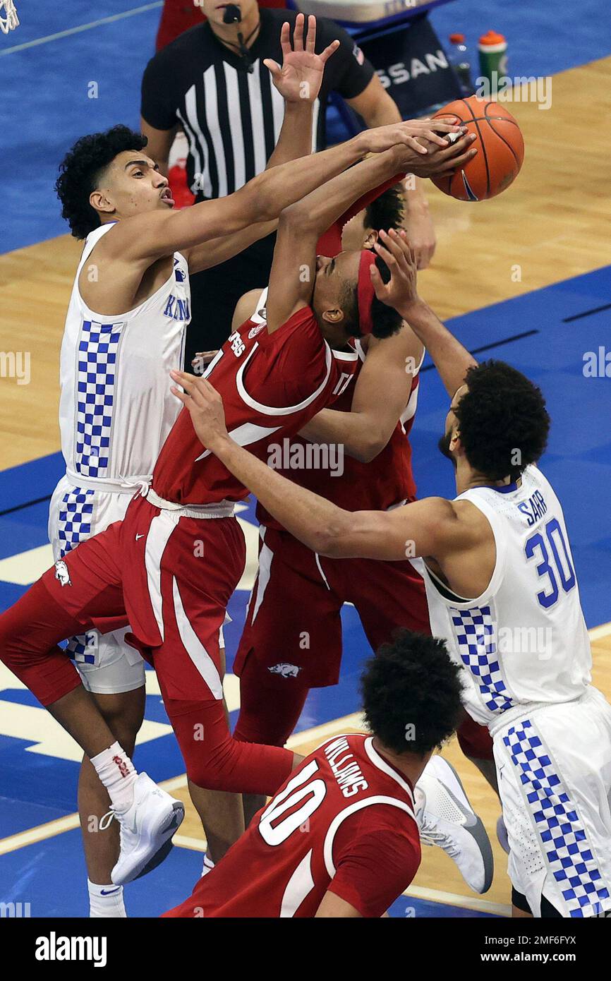 Kentucky's Jacob Toppin, left, fouls Arkansas' Jalen Tate in the ...