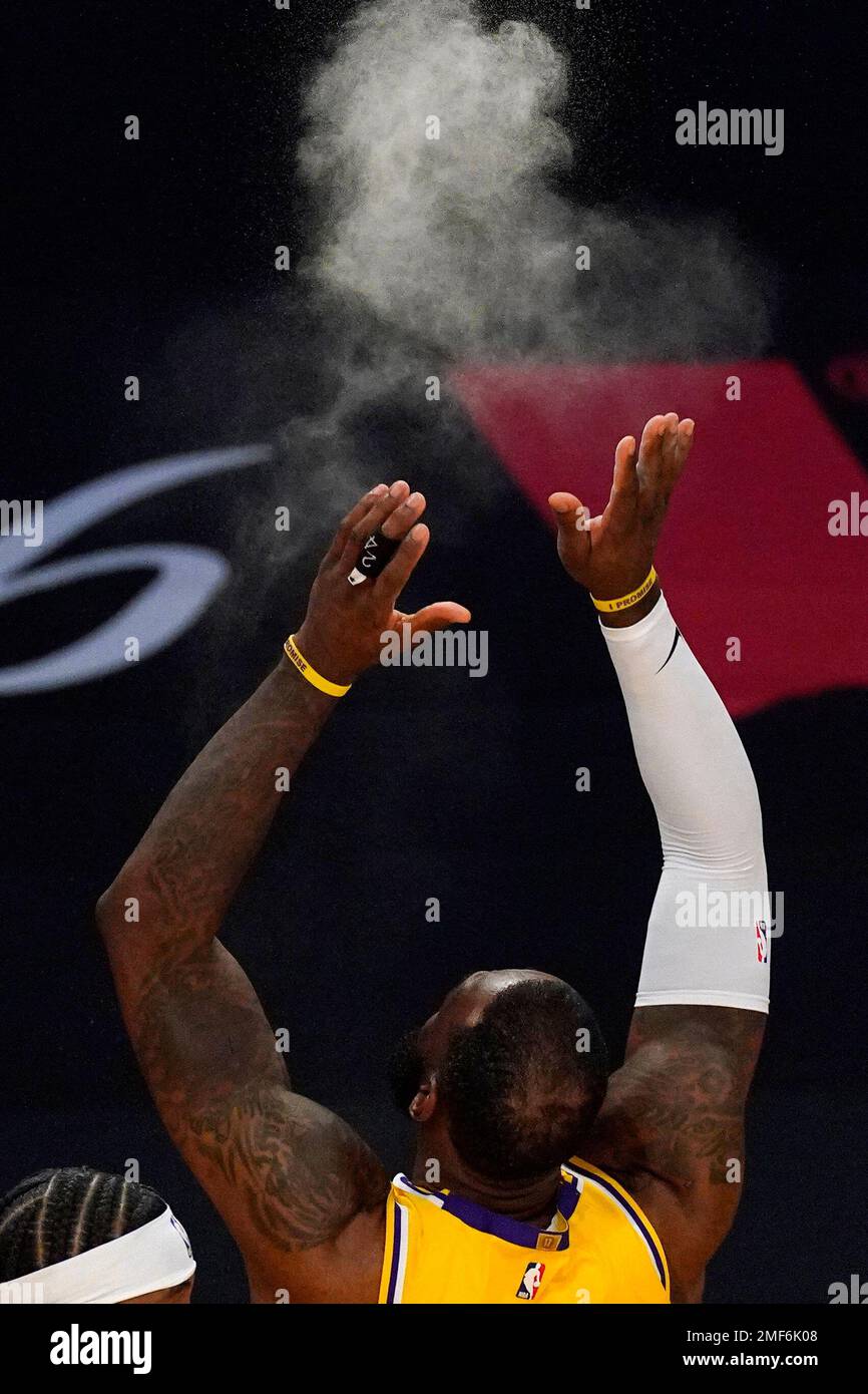 Los Angeles Lakers forward LeBron James throws powder in the air prior ...