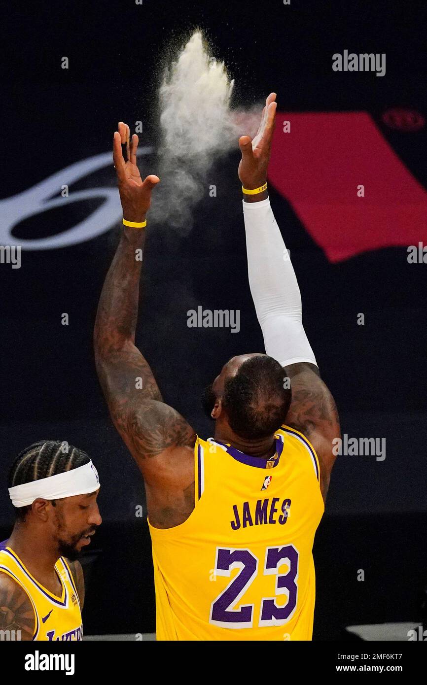 Los Angeles Lakers forward LeBron James throws powder in the air prior ...