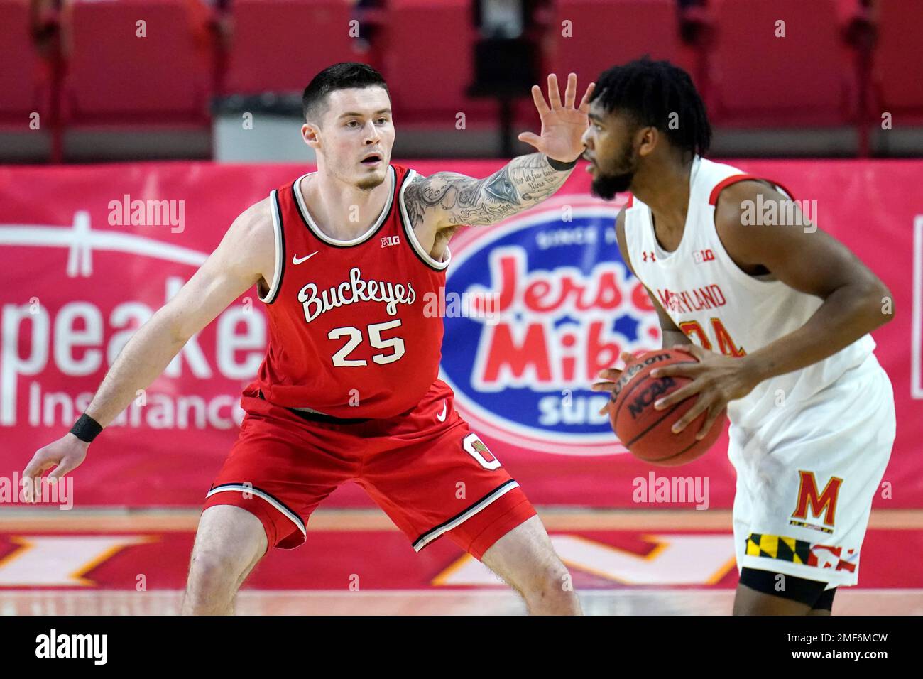 Ohio State forward Kyle Young (25) defends against Maryland forward ...