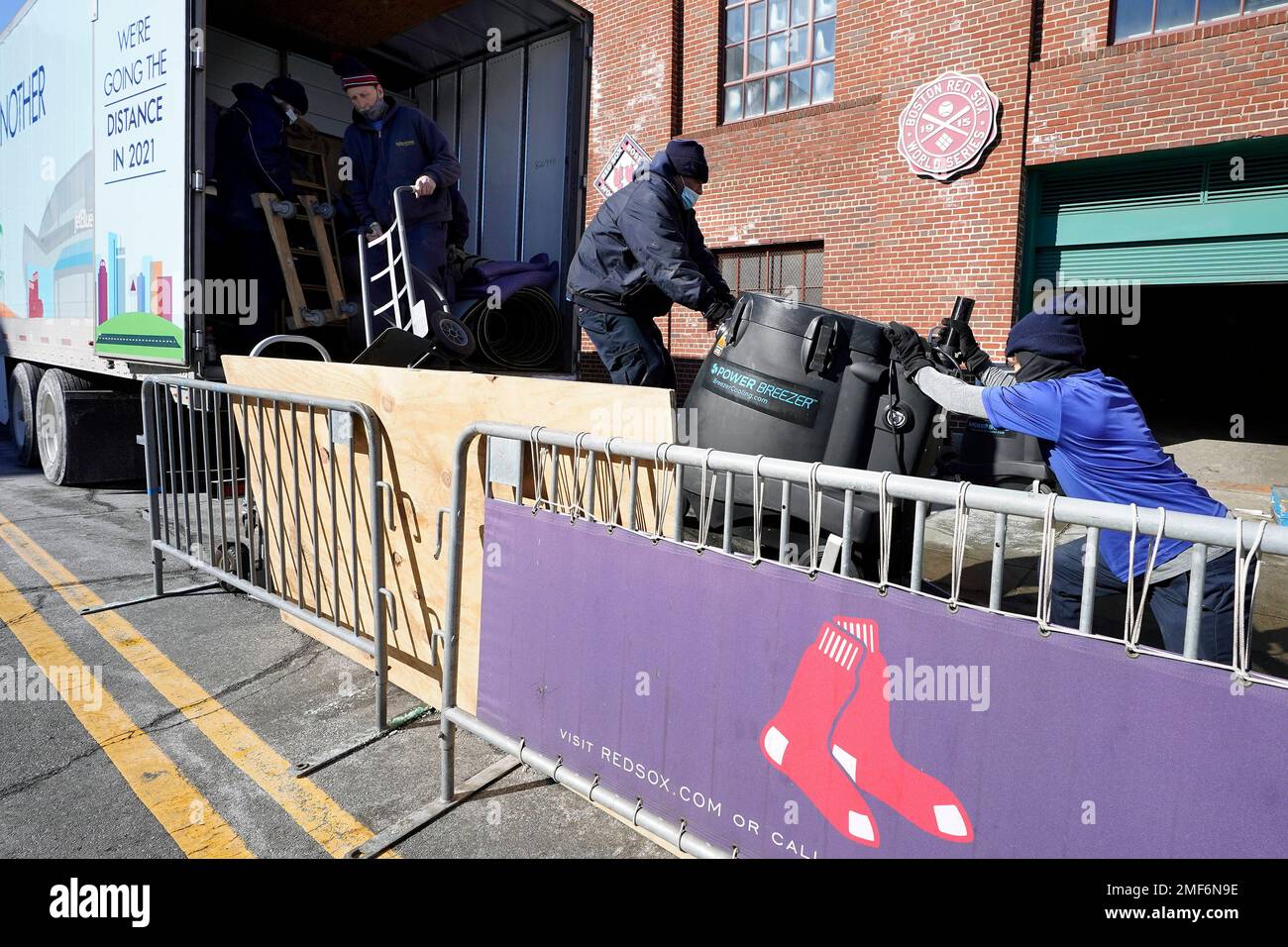 Workers load equipment onto the Boston Red Sox baseball team's truck ...