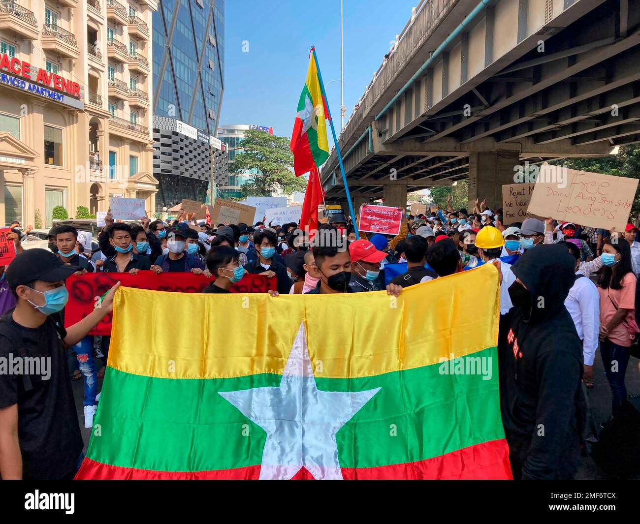 Protesters hold the Myanmar flag as they gather in Yangon, Myanmar on ...
