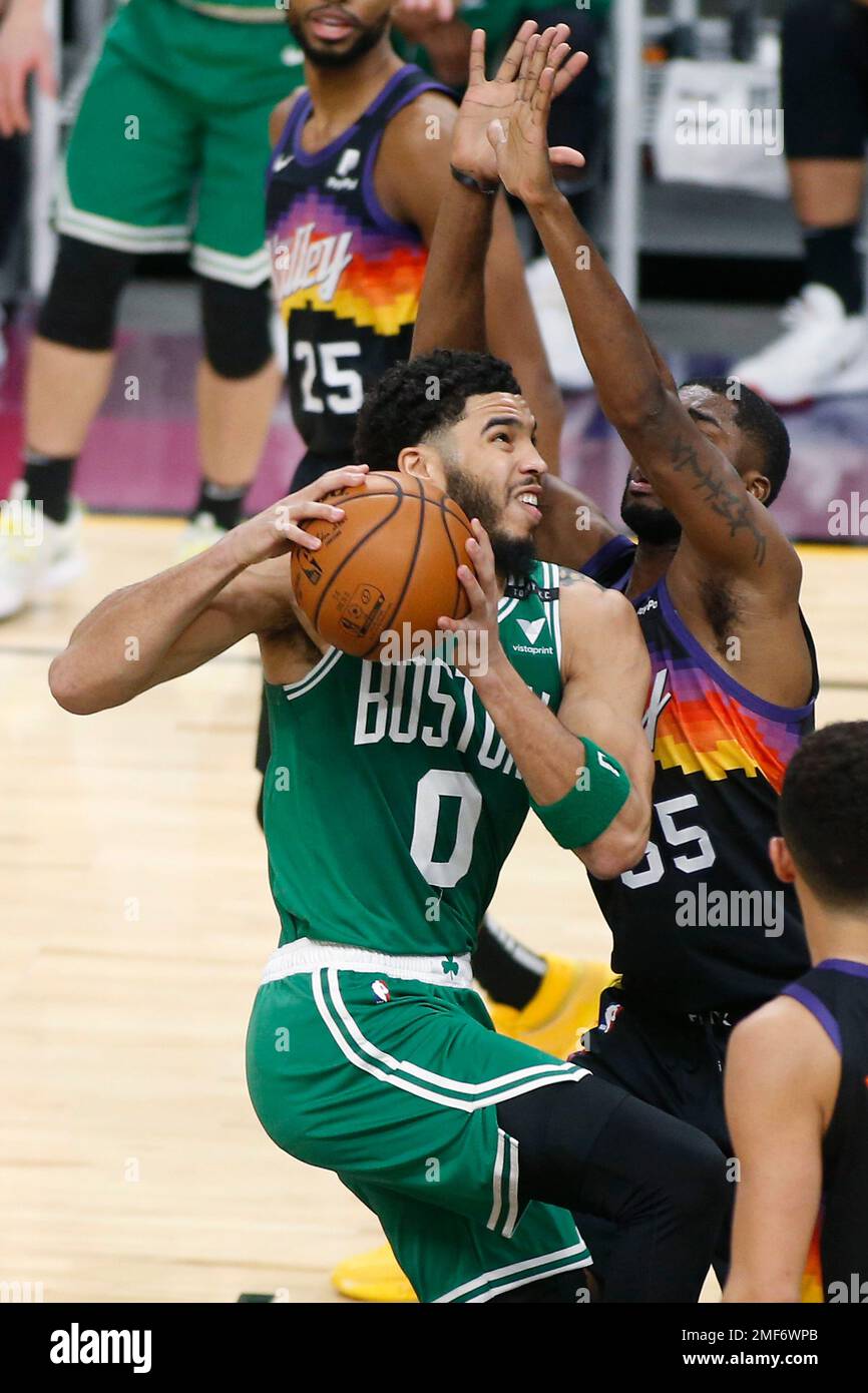 Boston Celtics forward Jayson Tatum (0) drives to the basket as Phoenix ...