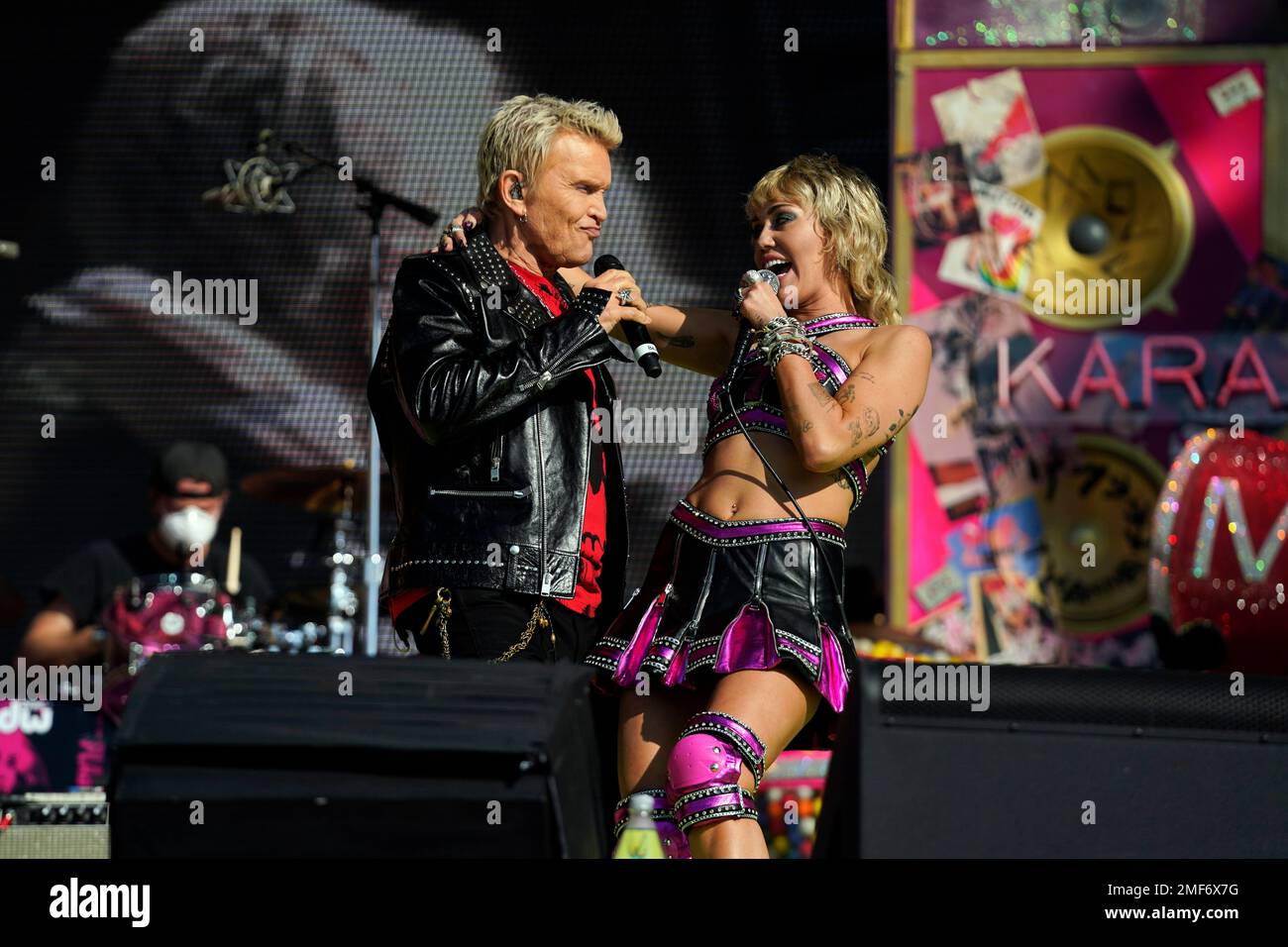 Miley Cyrus, right, and Billy Idol perform before the Kansas City ...