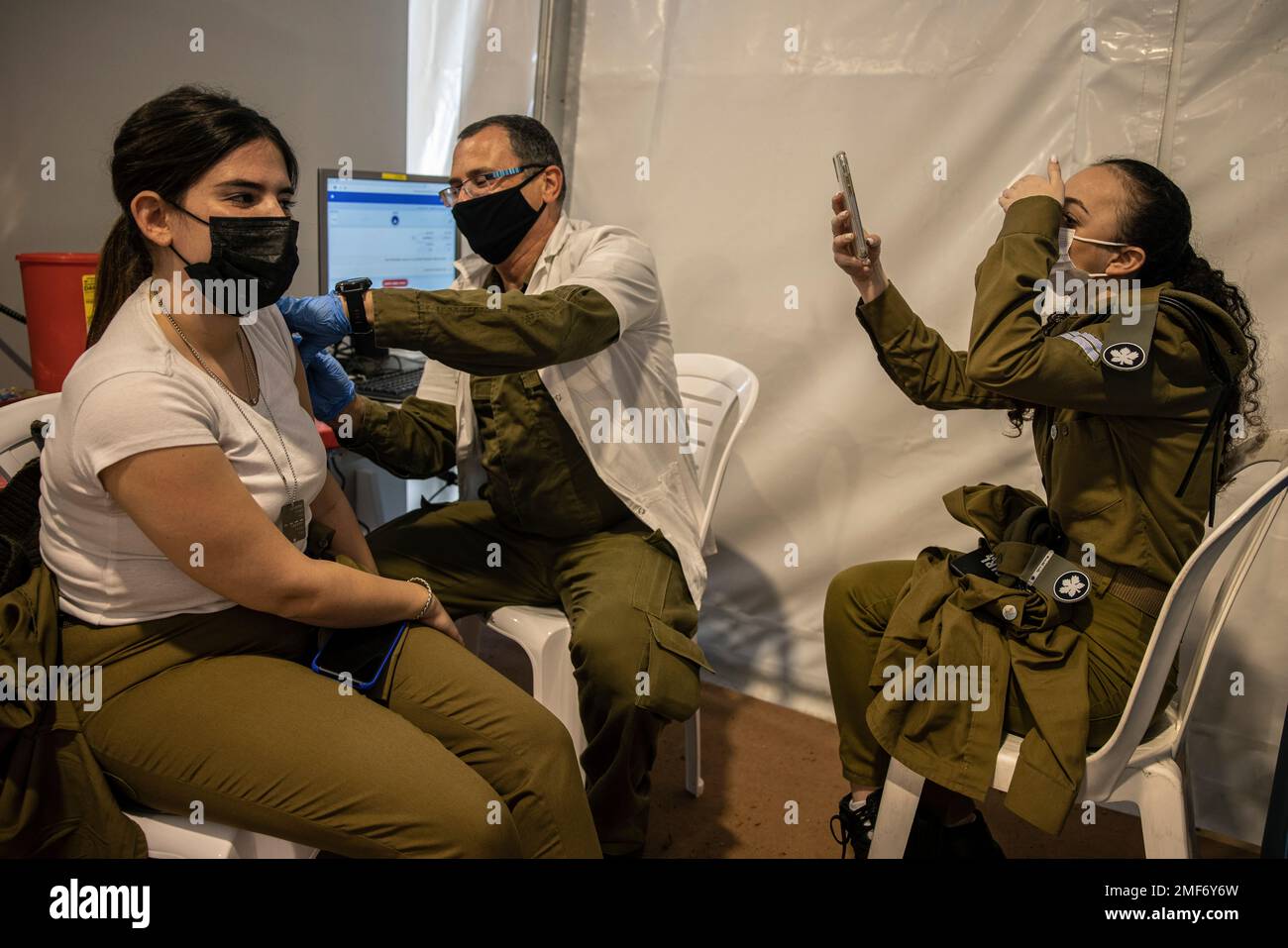 An Israeli soldier receives a Pfizer-BioNTech COVID-19 vaccine, at an ...