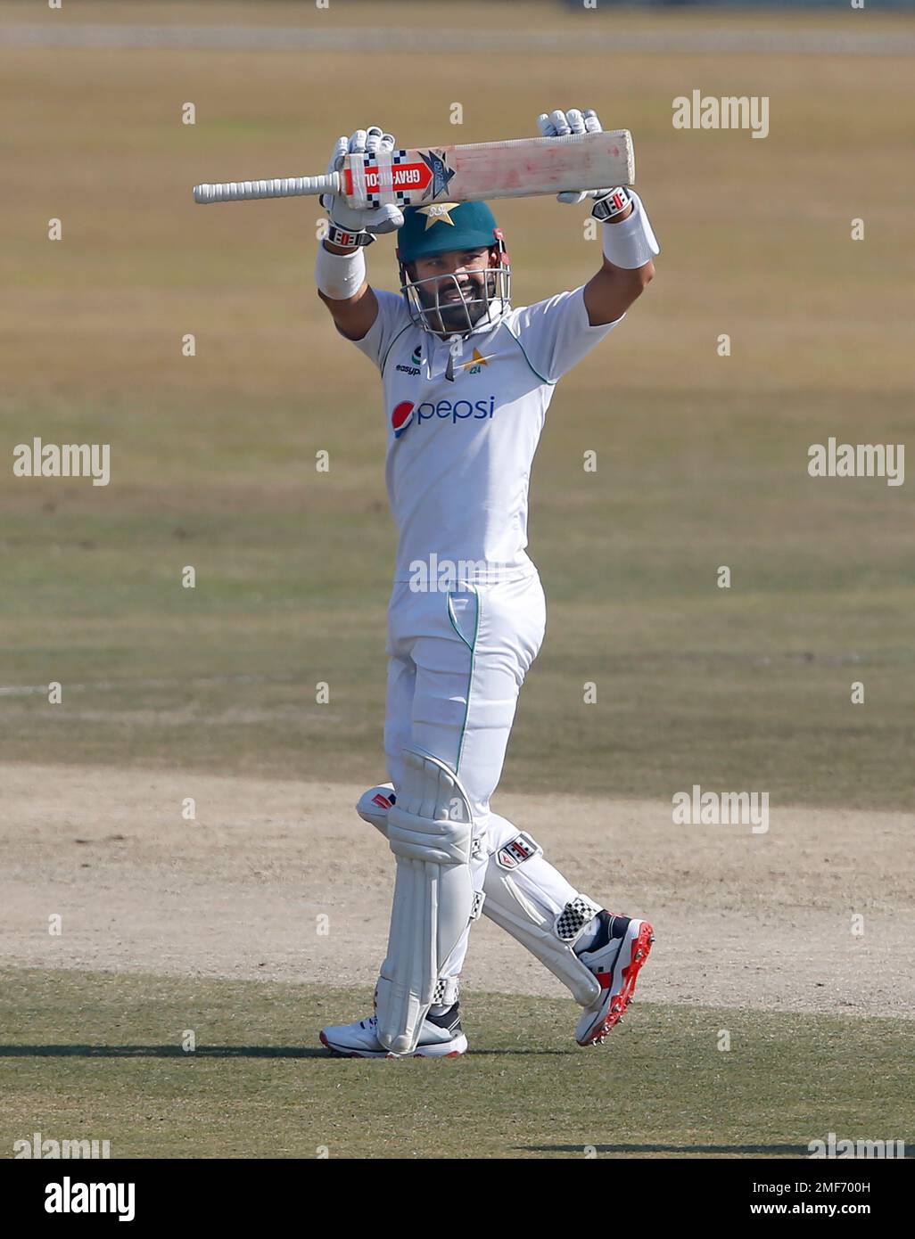 Pakistan's Mohammad Rizwan raises bat to celebrate his fifty during the ...