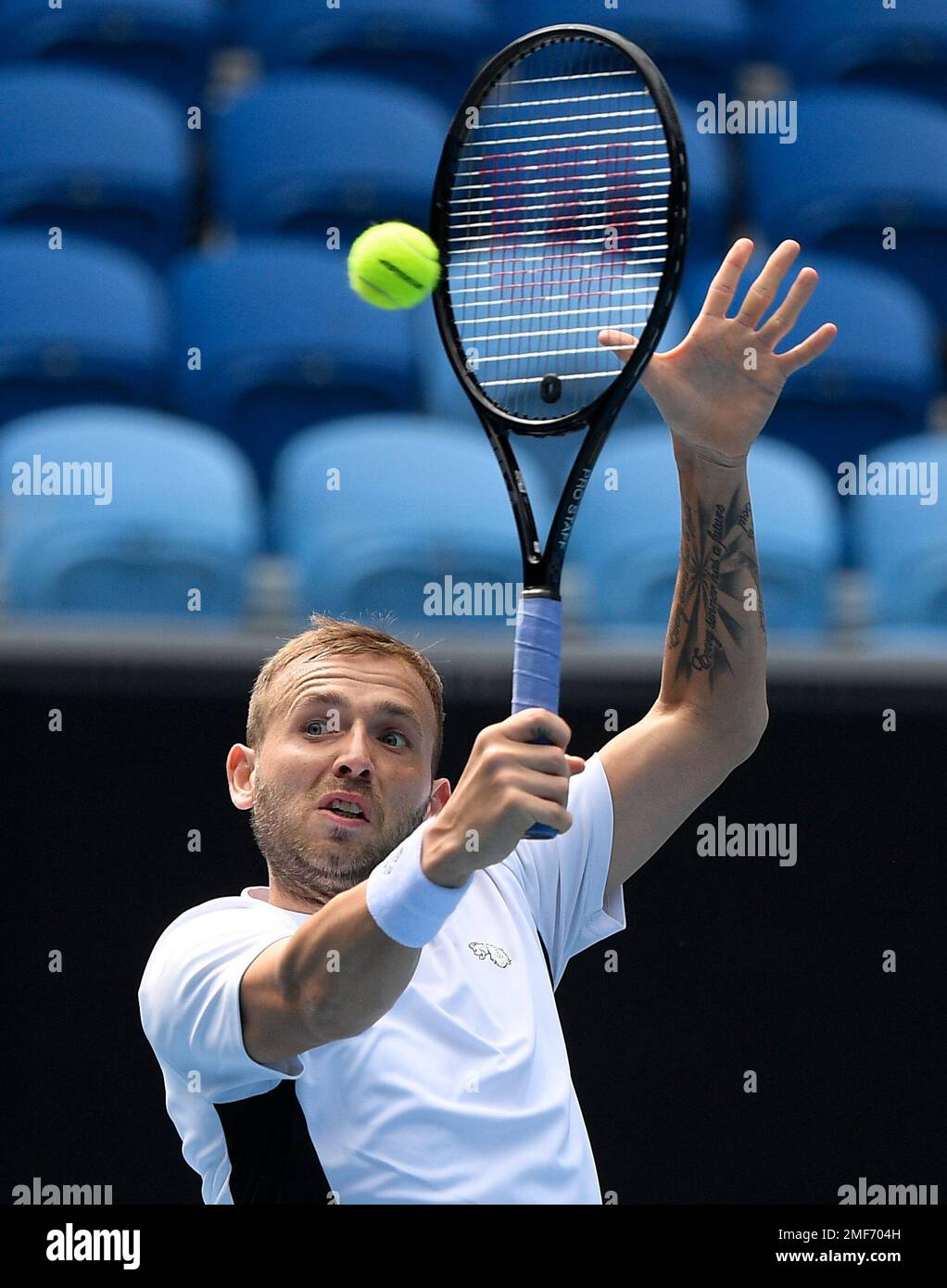 Britain's Daniel Evans makes a backhand return to Canada's Felix Auger ...