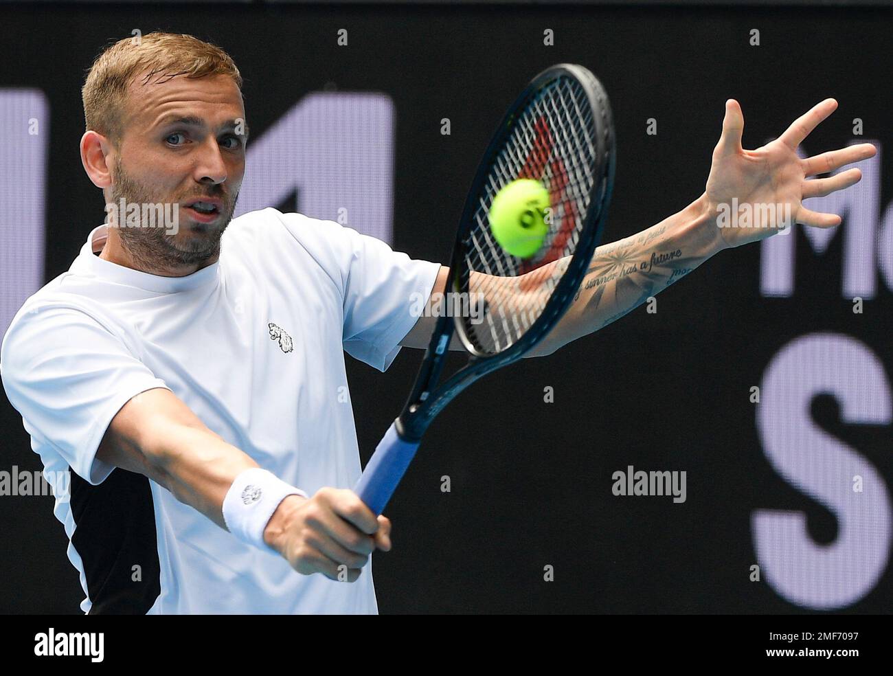Britain's Daniel Evans makes a backhand return to Canada's Felix Auger ...