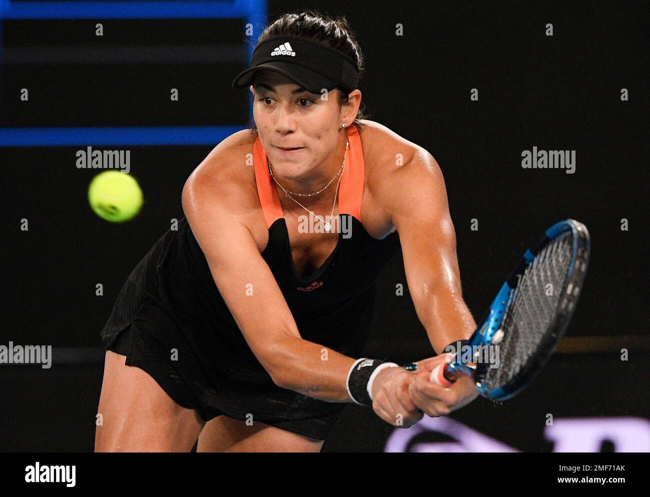 CORRECTS SPELLING: Spain's Garbine Muguruza makes a backhand return to Australia's Ash Barty in ...