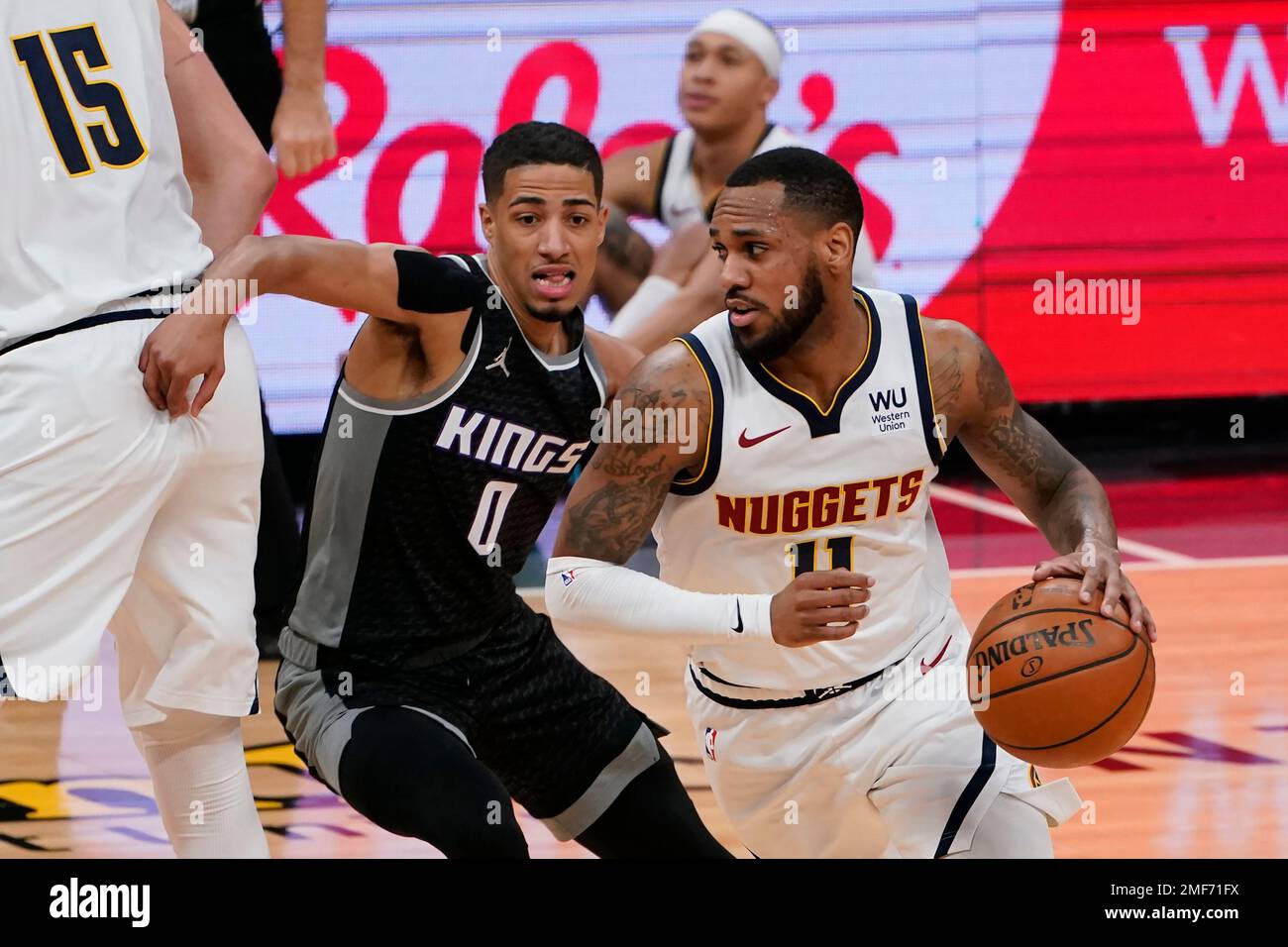 Sacramento Kings guard Tyrese Haliburton, left, goes around a screen as ...