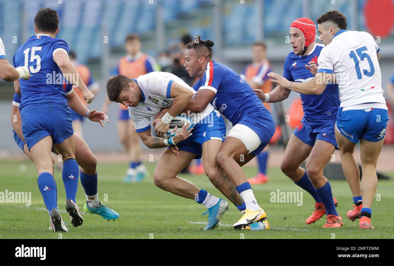 Italy's Luca Sperandio, center, left, is tackled by France's Teddy ...