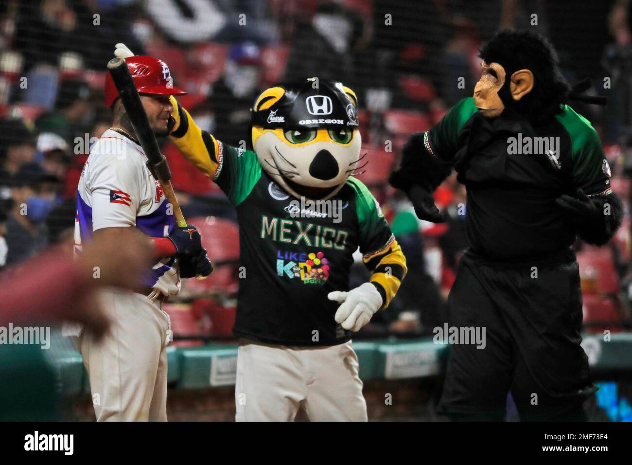 Mexico mascots jokes with Puerto Rico's Yadier Molina, left, during the ...