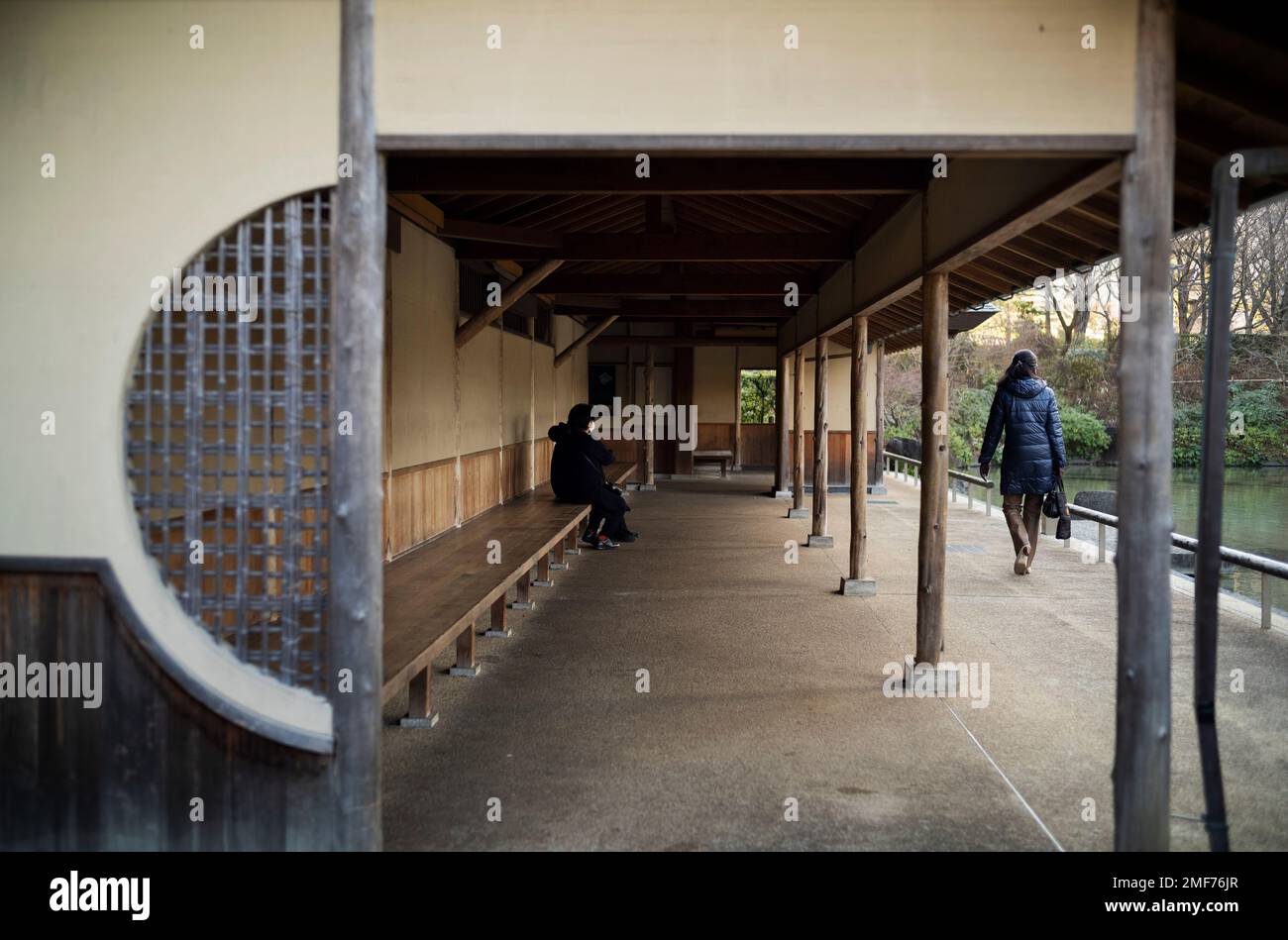 People wearing face masks rest at Hinokicho Park in Tokyo on Friday ...