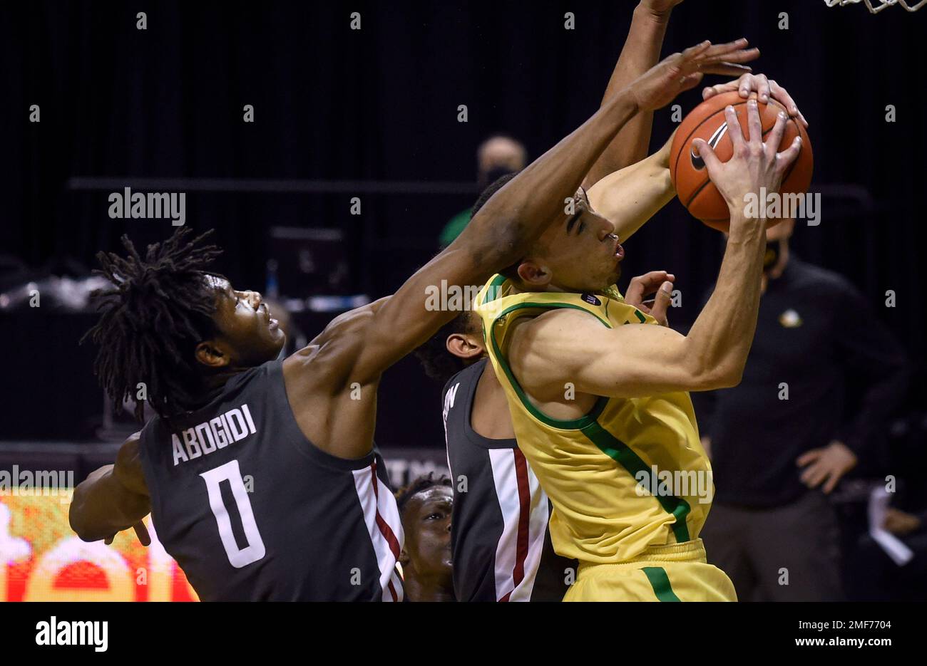 Oregon guard Chris Duarte (5) hauls in a rebound next to Washington ...