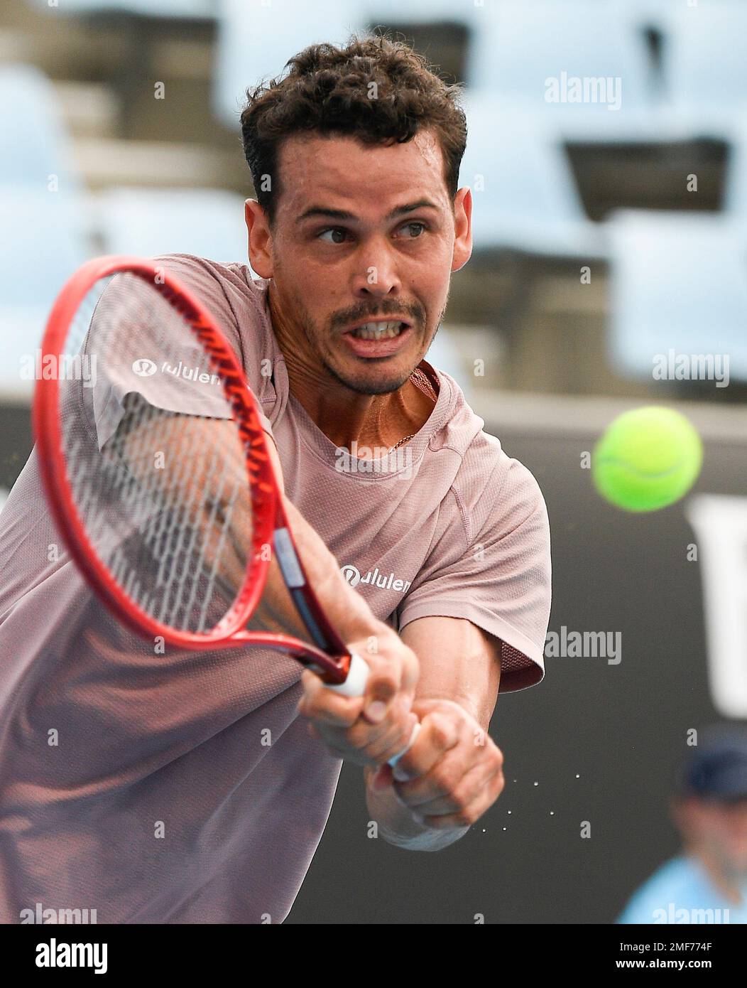 Australia's Alex Bolt makes a backhand return to Switzerland's Stan ...