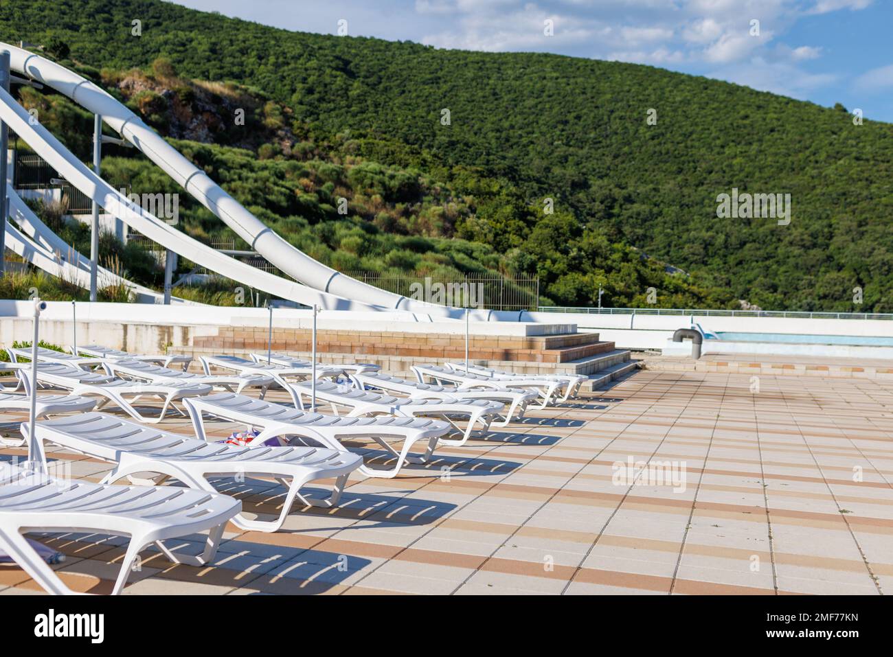 Empty indoor mountain summer water park with high extreme winding white ...