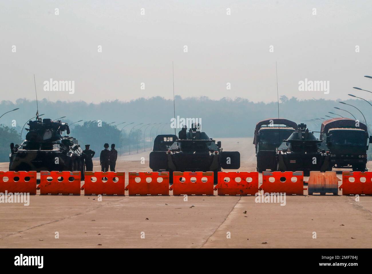 Myanmar's military personnel stand guard at a checkpoint manned with ...