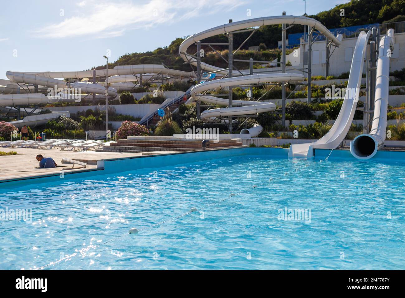 Empty indoor mountain summer water park with high extreme winding white ...