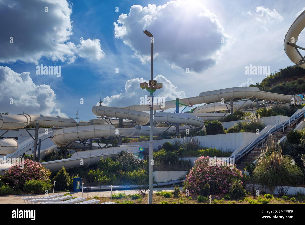 Empty indoor mountain summer water park with high extreme winding white ...