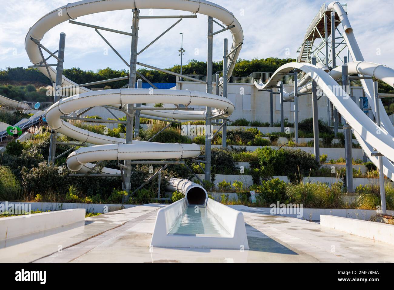 Empty indoor mountain summer water park with high extreme winding white ...
